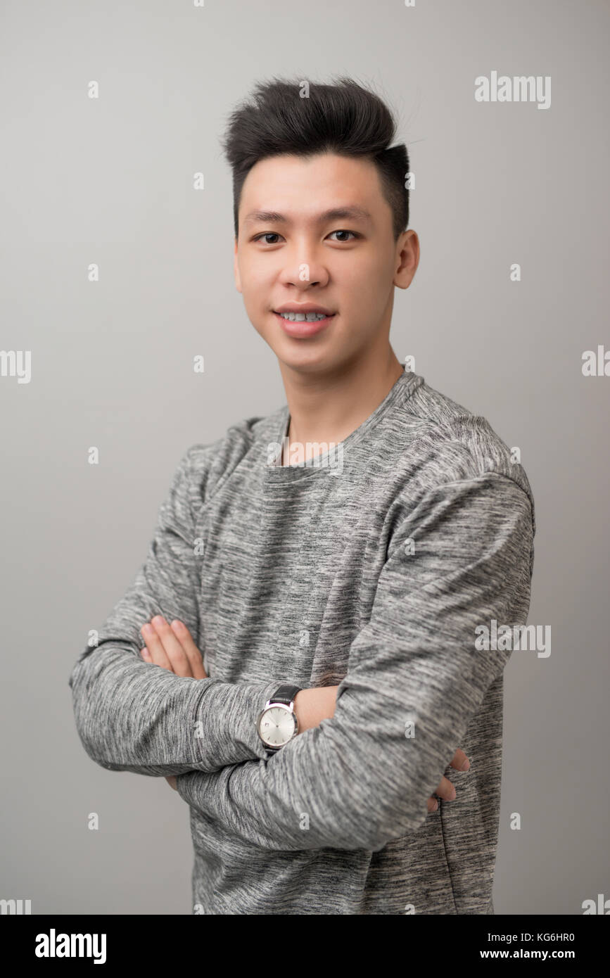 Portrait of good looking asian man over gray background Stock Photo - Alamy