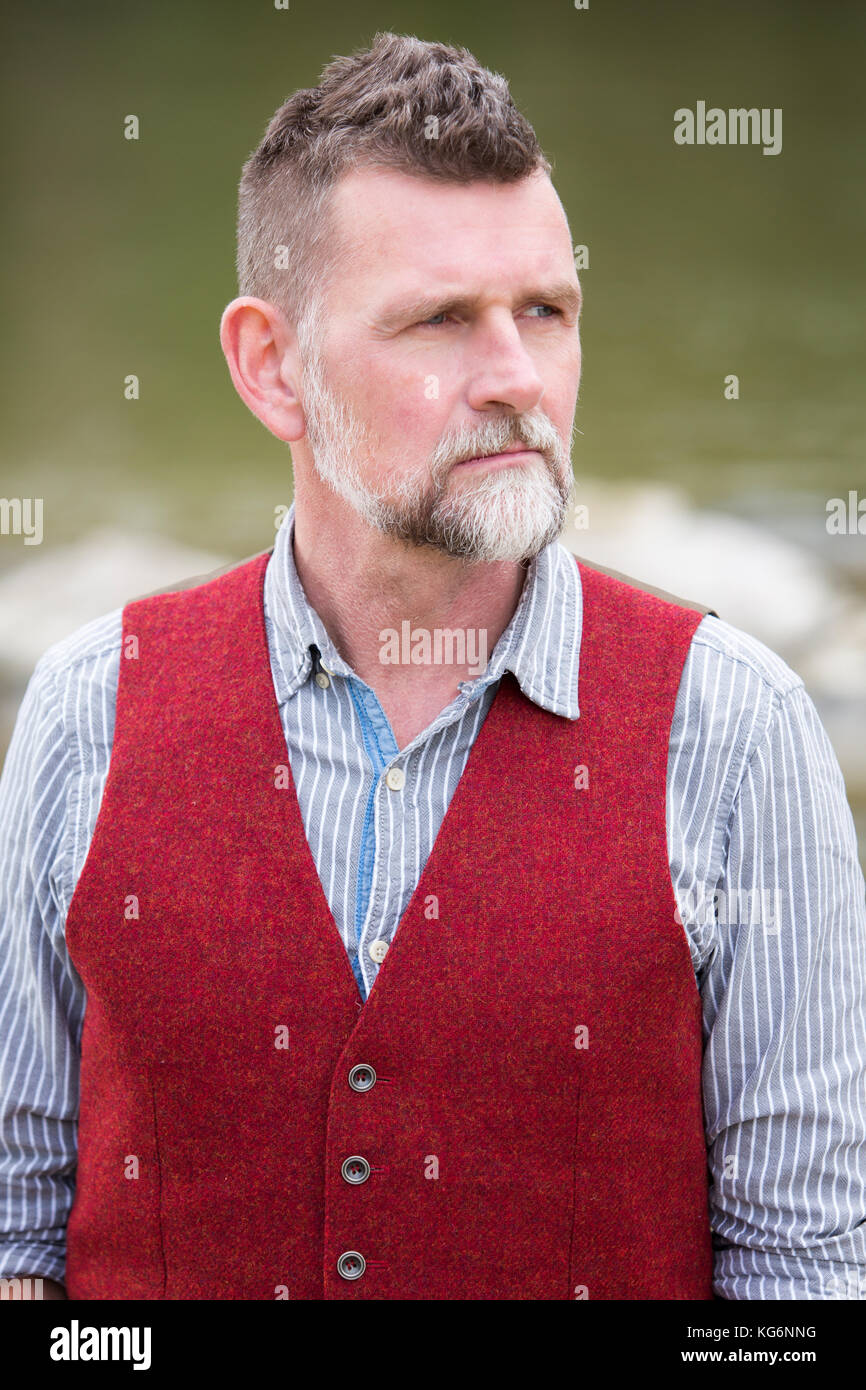 portrait of handsome man in his 50s wearing a shirt and red vest Stock ...