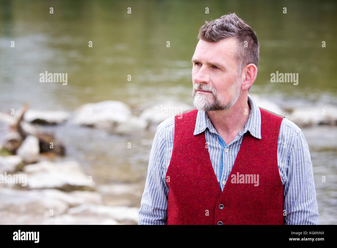portrait of handsome man in his 50s standing by the river Stock Photo ...