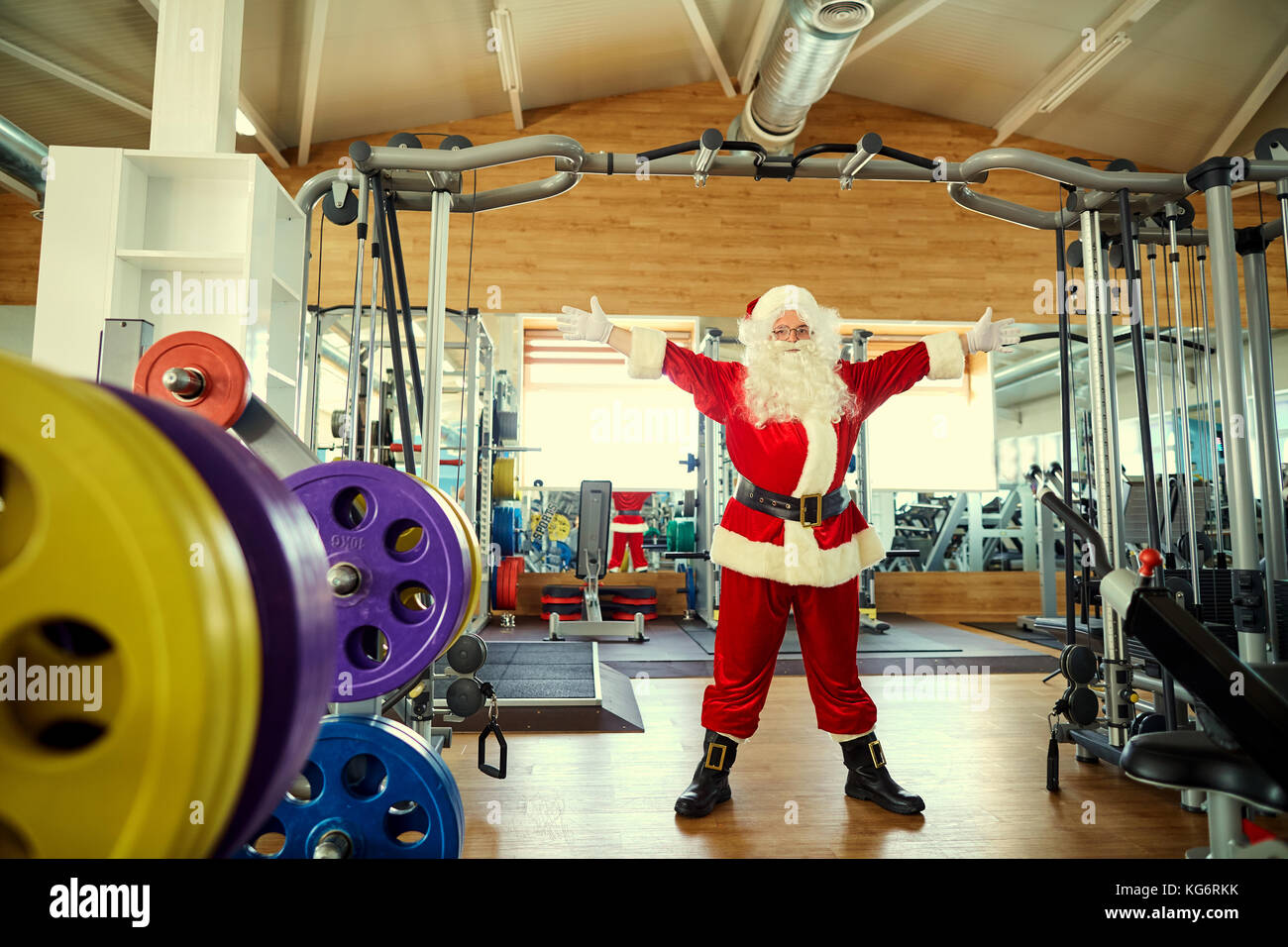 Santa Claus with dumbbells in the gym for Christmas Stock Photo - Alamy