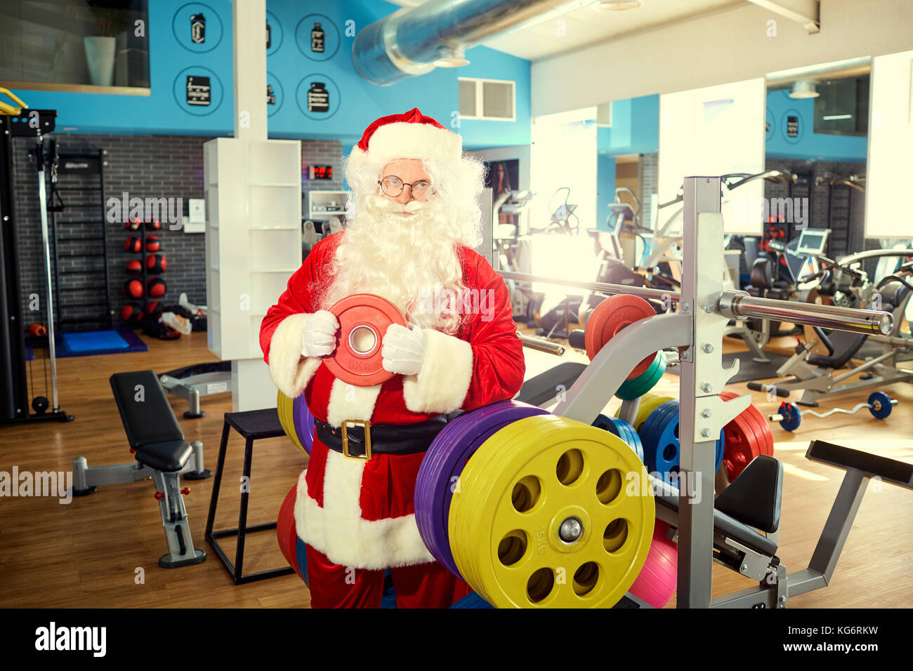 Santa Claus with dumbbells in the gym for Christmas Stock Photo - Alamy
