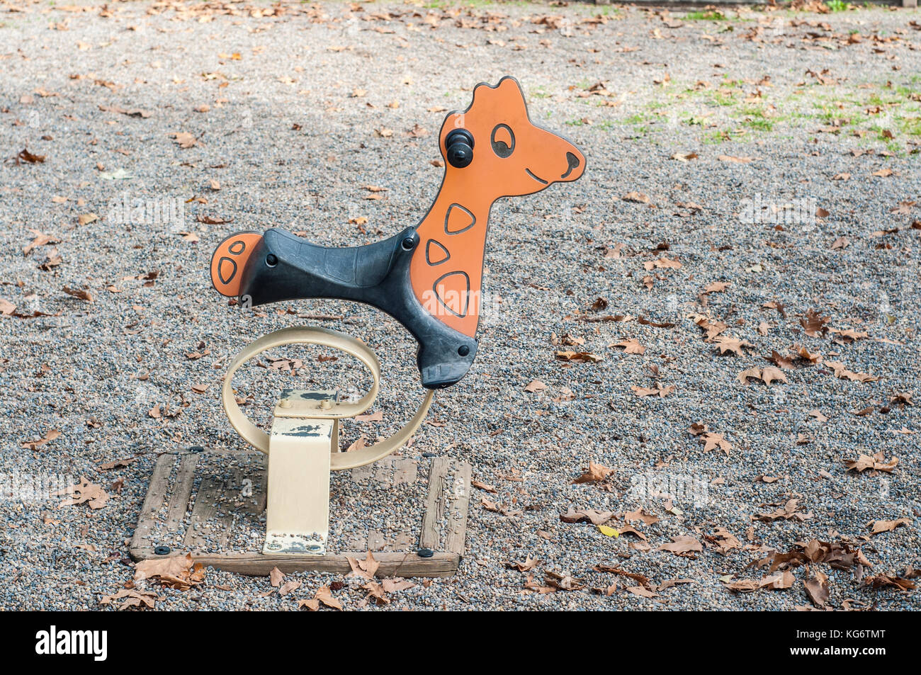 Public urban playground with a spring rider with animal shape on the ...