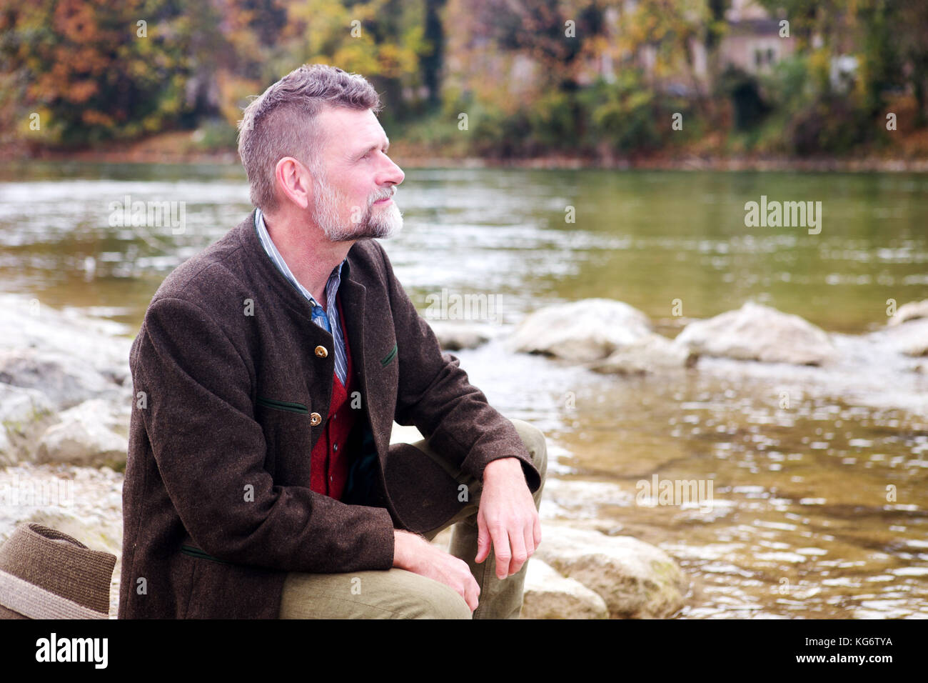 portrait of bavarian man in his 50s sitting by the river Stock Photo ...