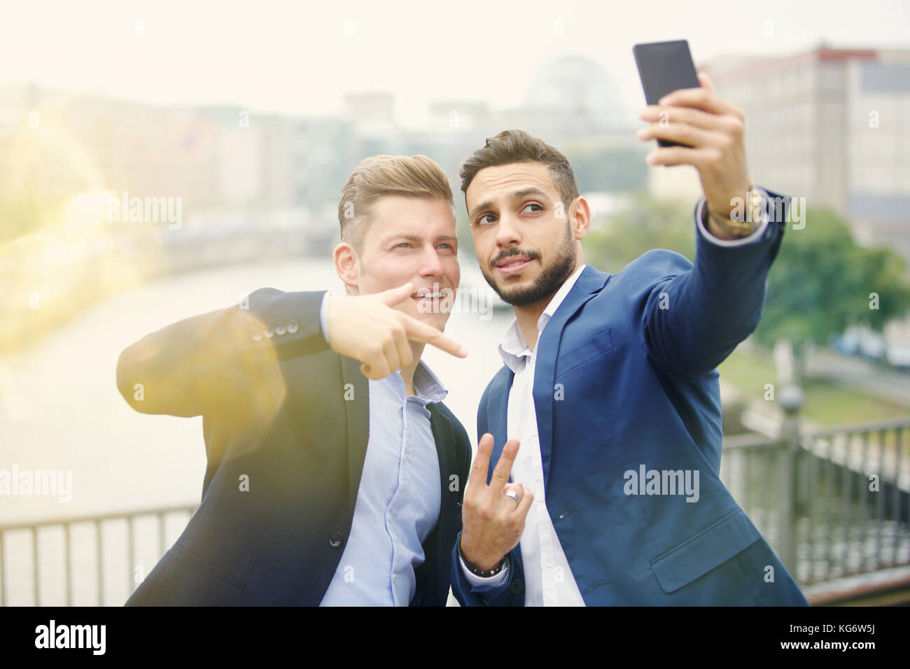 two handsome businessmen talking a selfie and having fun Stock Photo ...