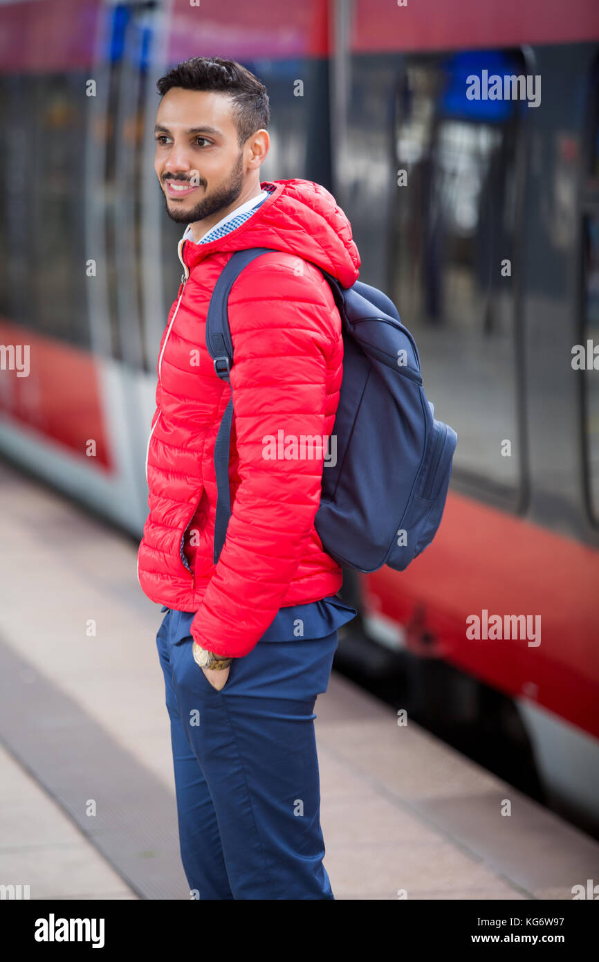 handsome man standing on platform at train station Stock Photo - Alamy