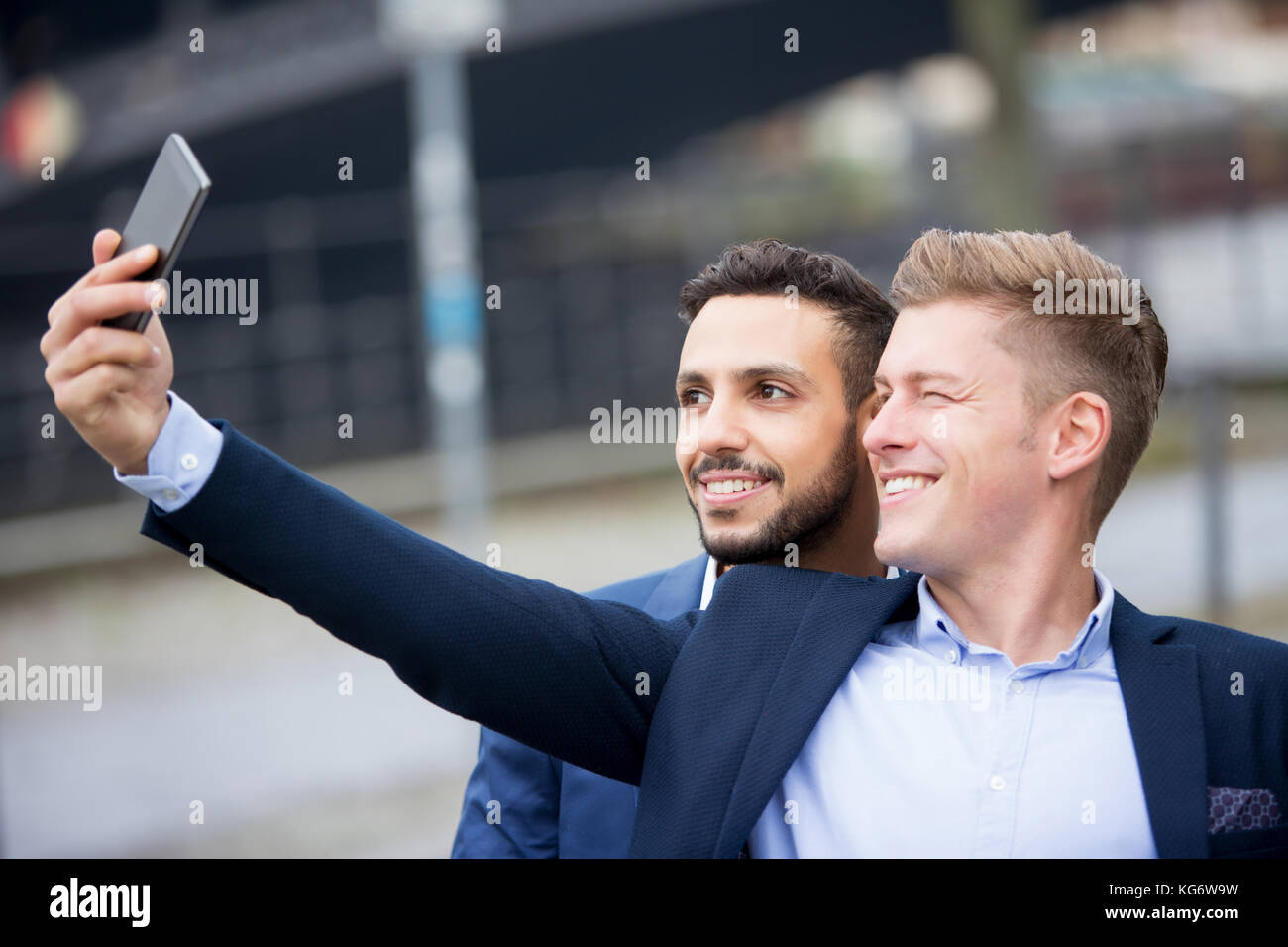 two handsome businessmen talking a selfie and having fun Stock Photo ...