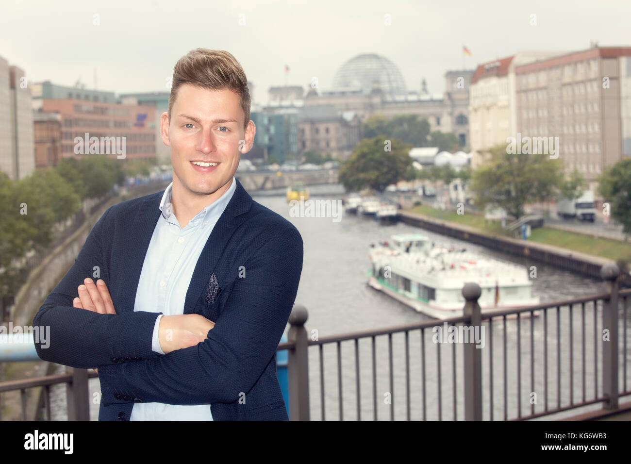 portrait of handsome blond man with german parliament in the background ...