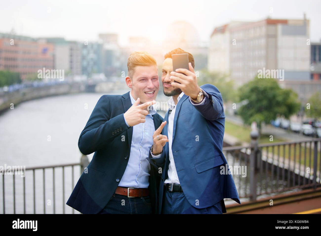 two handsome businessmen talking a selfie and having fun Stock Photo ...