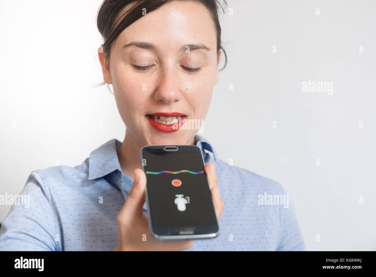 Woman talking on the phone with the digital voice assistant Stock Photo ...