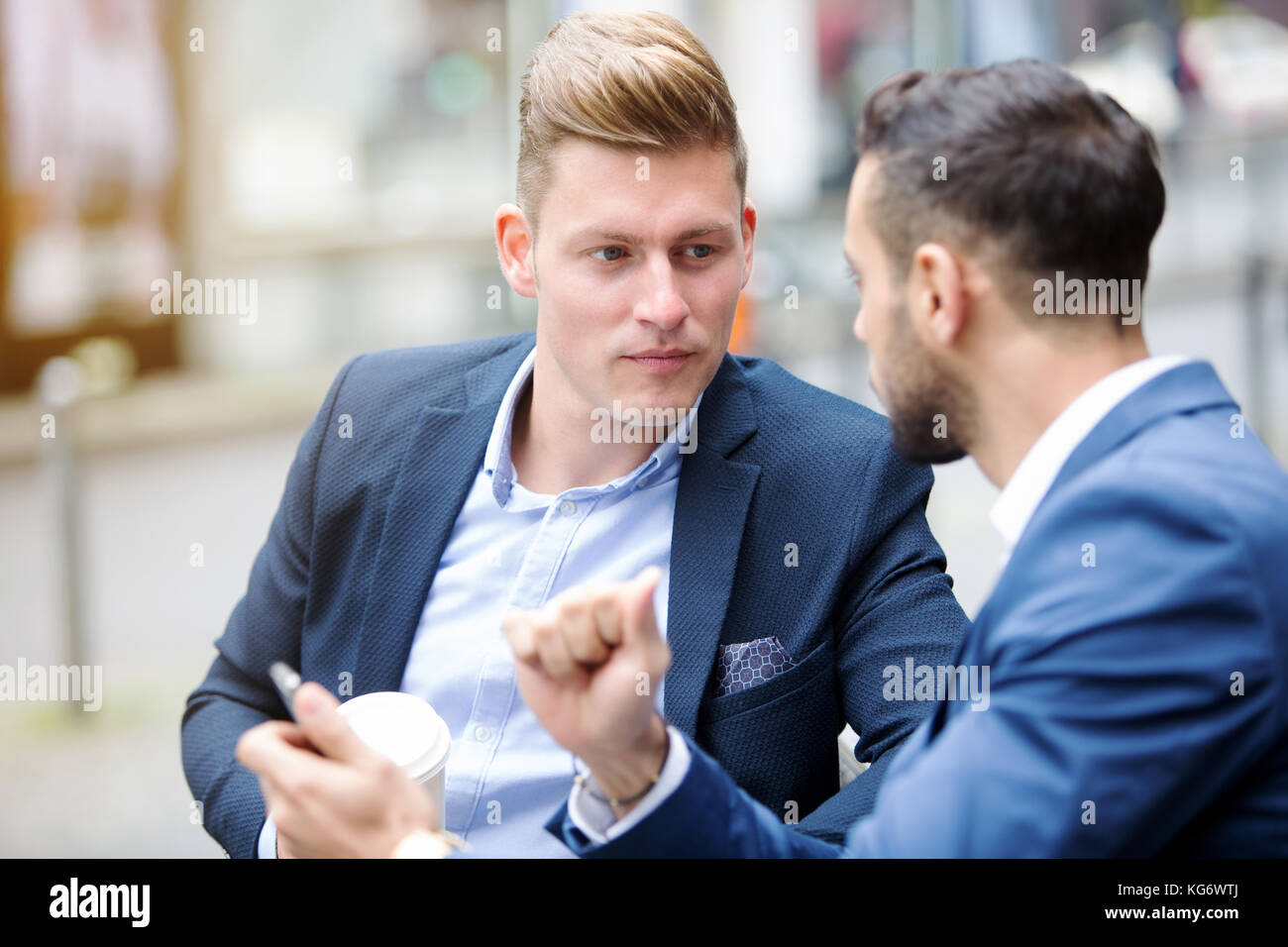 two handsome businessmen talking outside in the street Stock Photo - Alamy