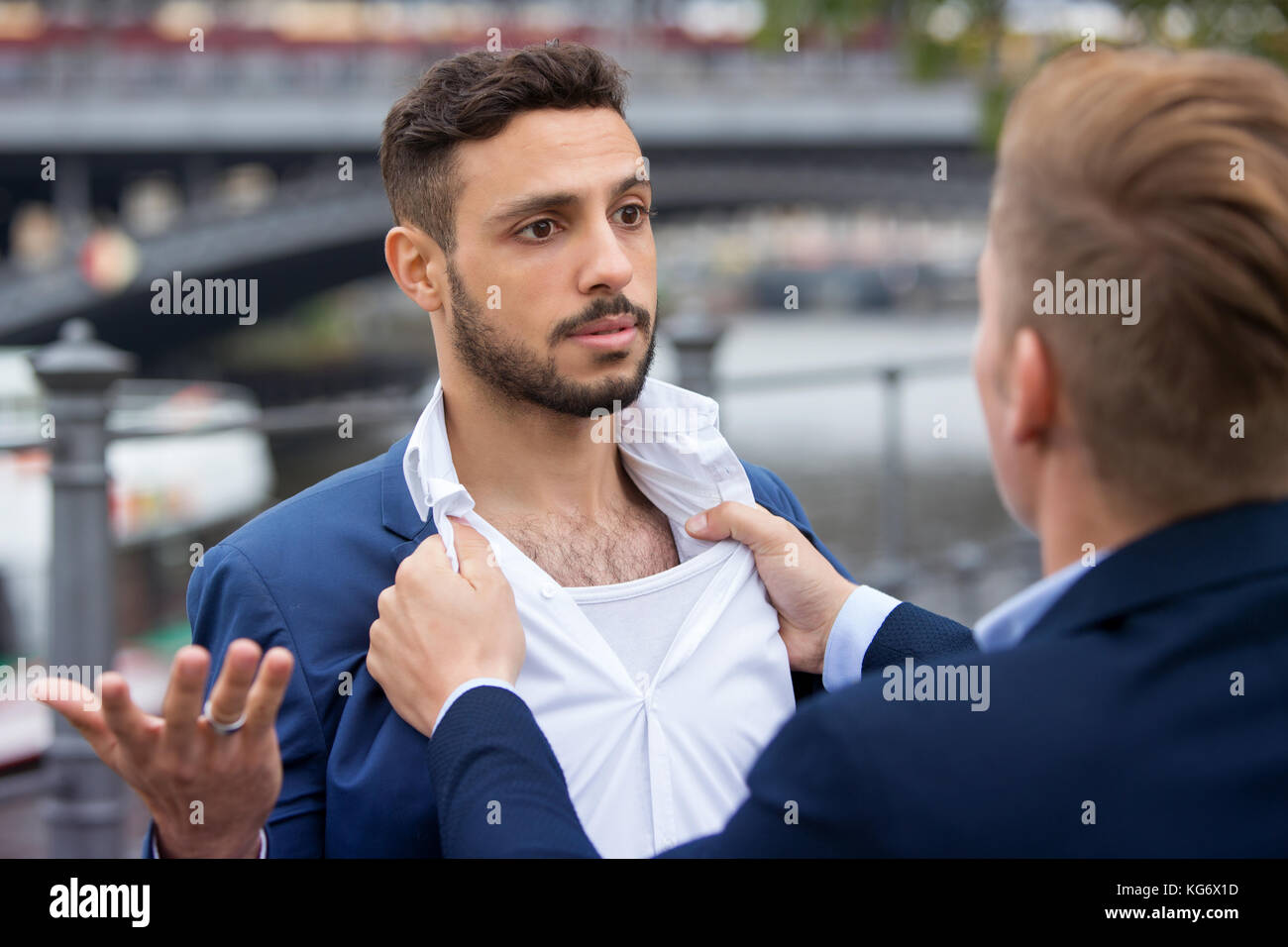 two young businessmen having a fight outside Stock Photo - Alamy