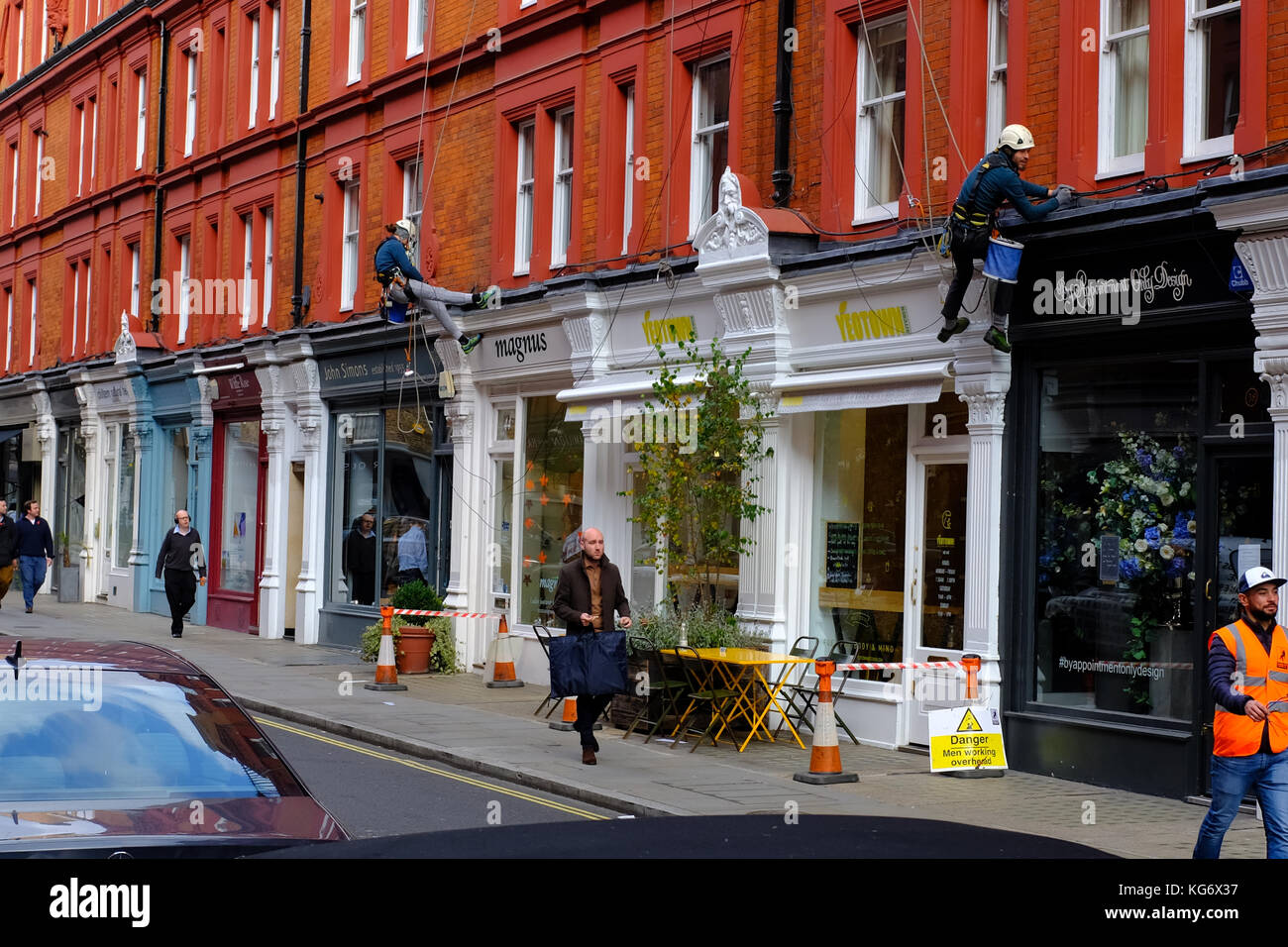 Workmen repairing a building in Chiltern Street, Marylebone, London UK ...