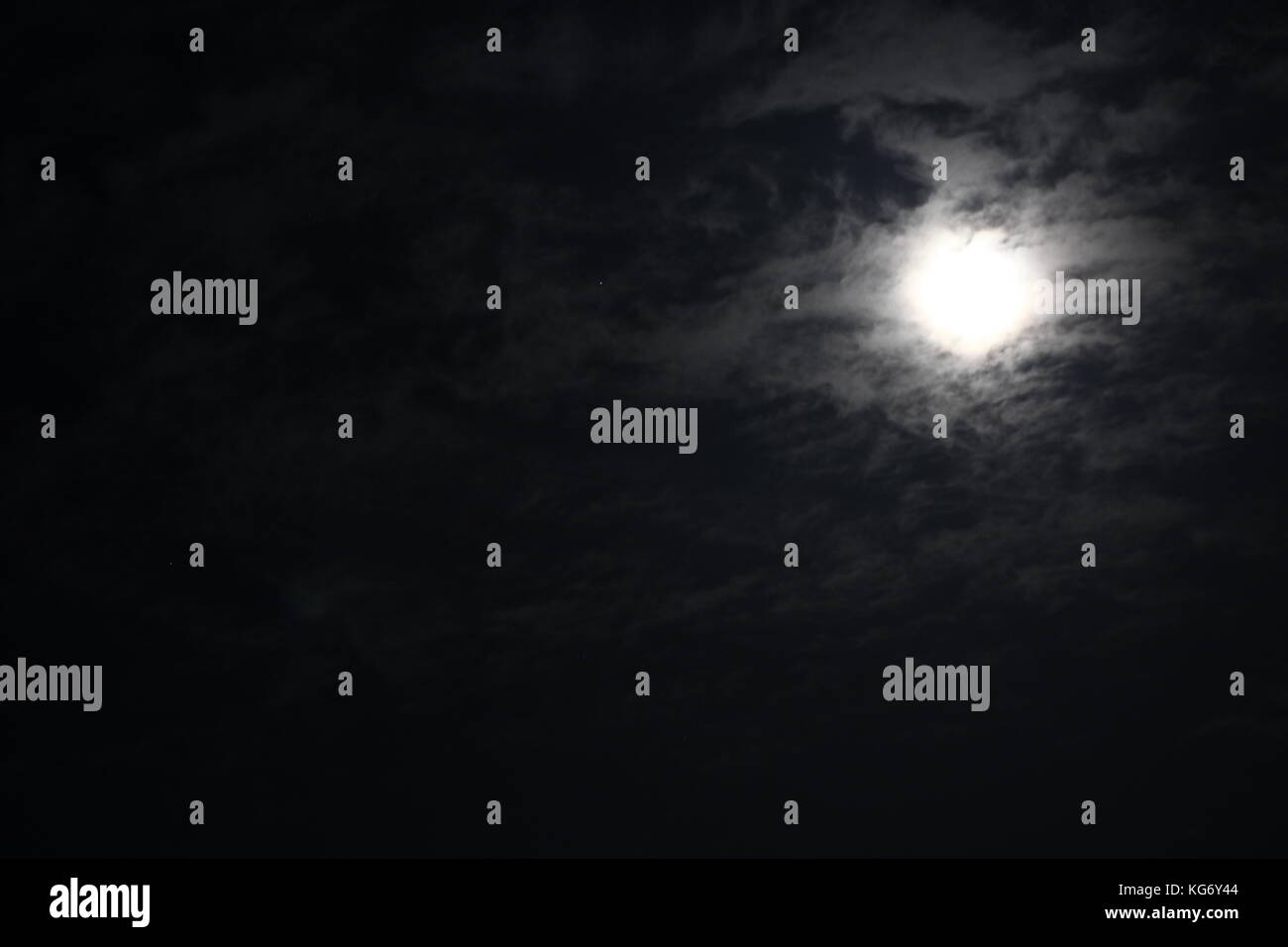 Photo of bright moon on a clouded night Stock Photo - Alamy