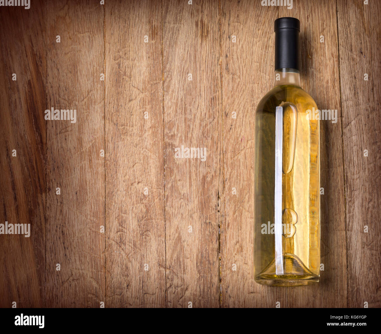 Glass bottle of wine on wooden table background Stock Photo - Alamy