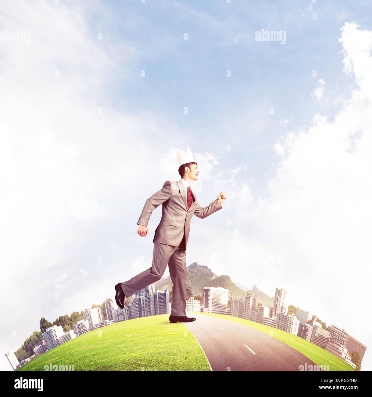 Young handsome businessman wearing white paper crown running in a hurry ...