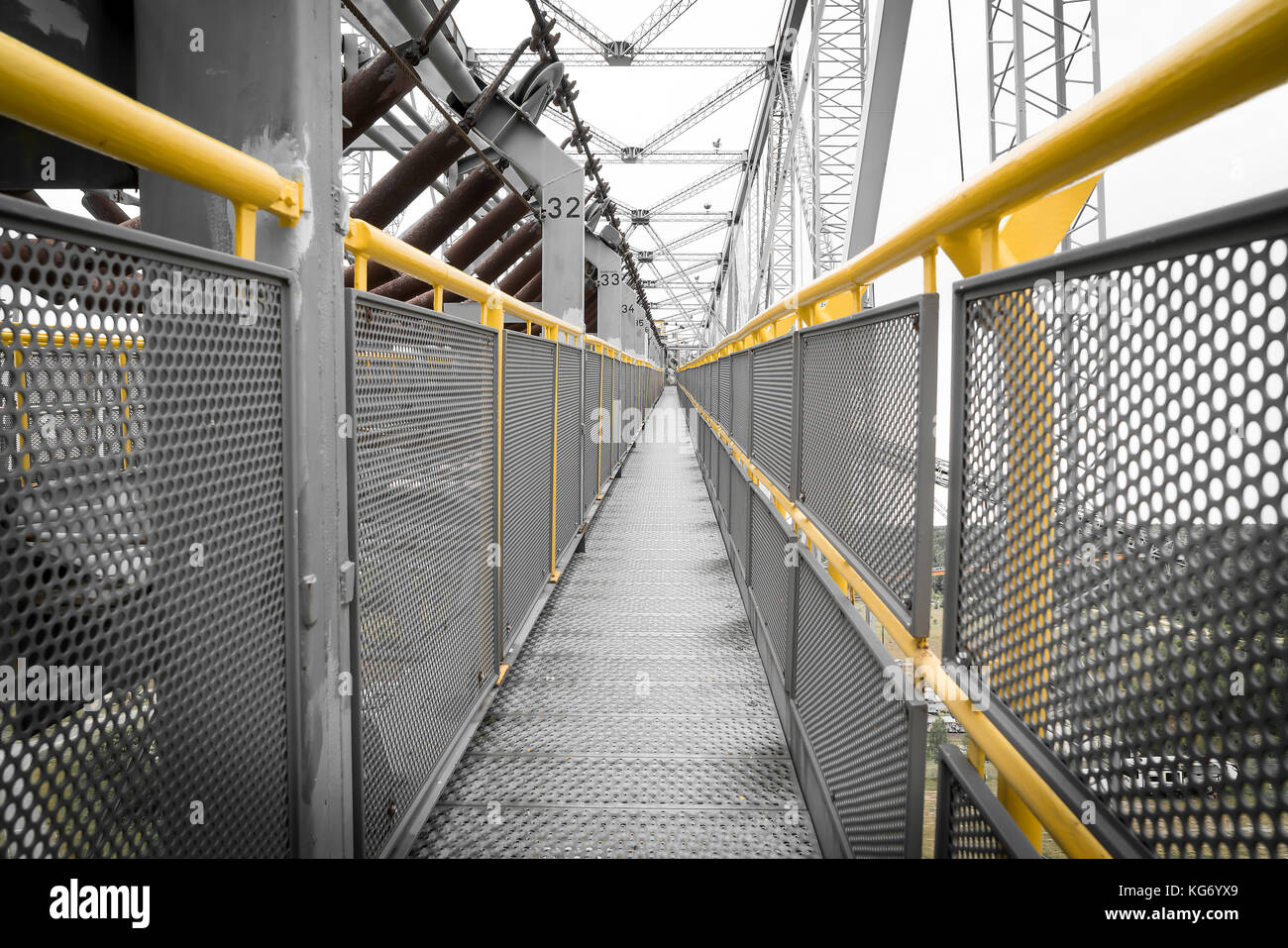 yellow railing of a transportation bridge Stock Photo - Alamy