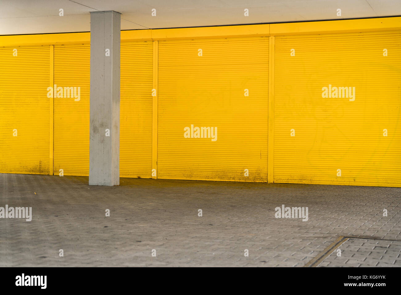 yellow roller shutter and pavement for backgrounds and compositions ...