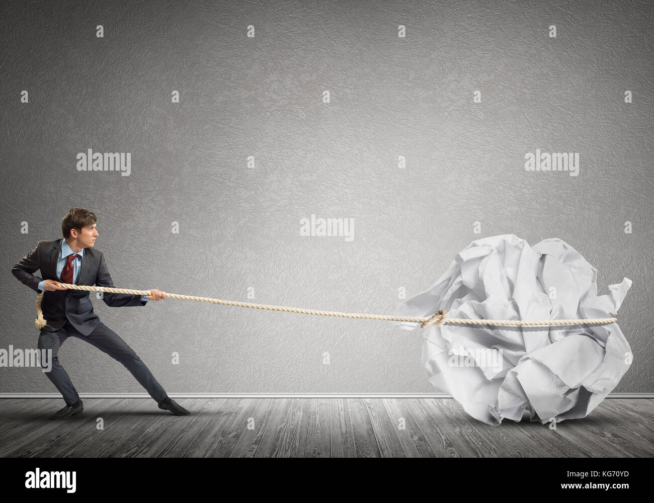 Young man making huge paper ball move Stock Photo - Alamy