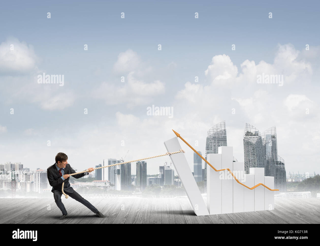 Young businessman outdoors making huge graph move Stock Photo - Alamy