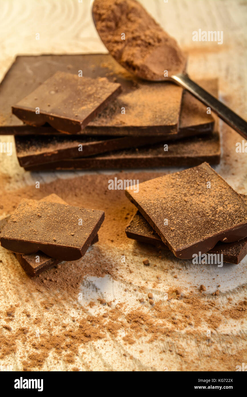 chocolate tablets with pieces on different sizes on bright wood ...