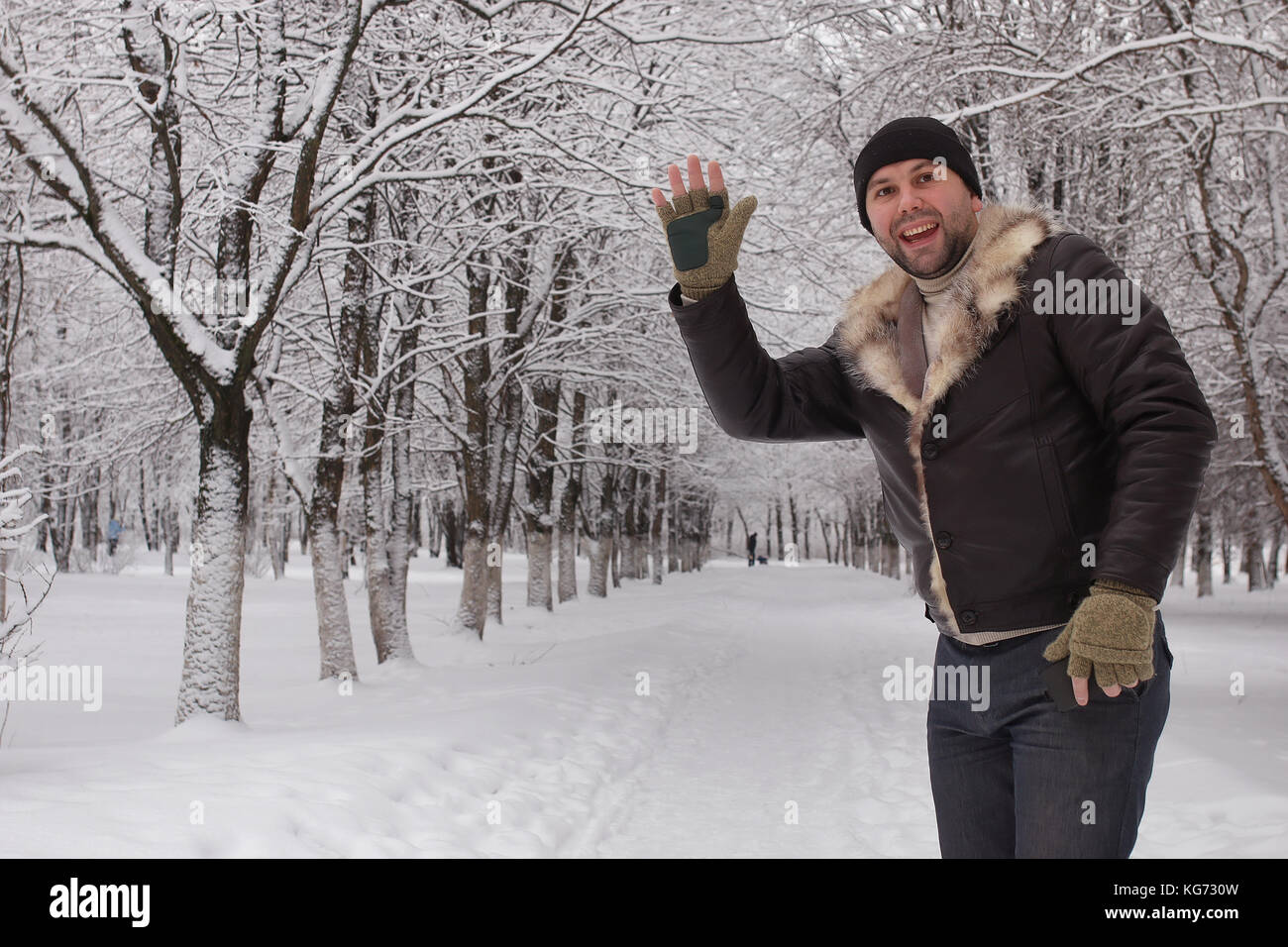 bearded man walking in a winter park snow season Stock Photo - Alamy