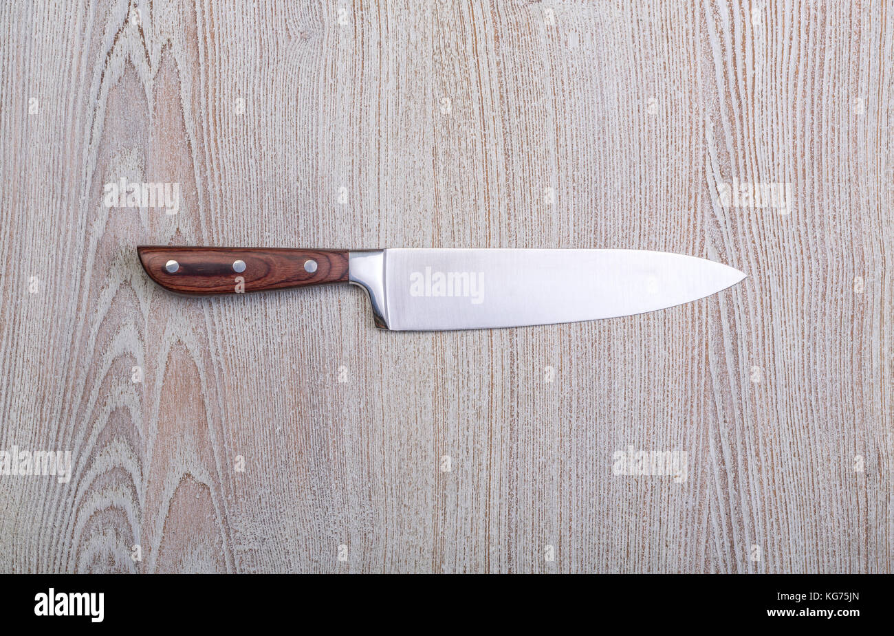 Knife on rustic kitchen table with copy space Stock Photo - Alamy