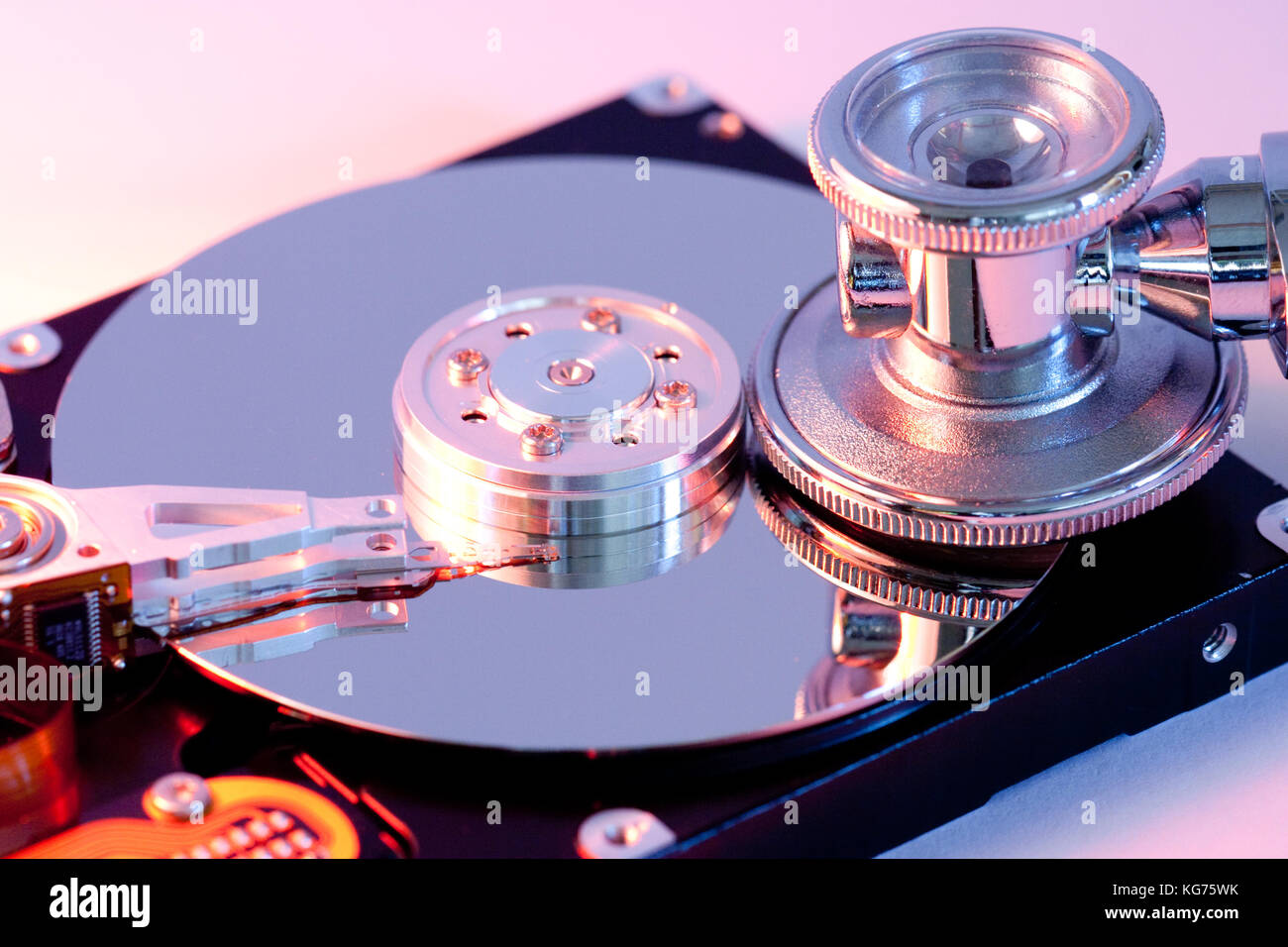 open computer hard disk with stethoscope and red light on white ...