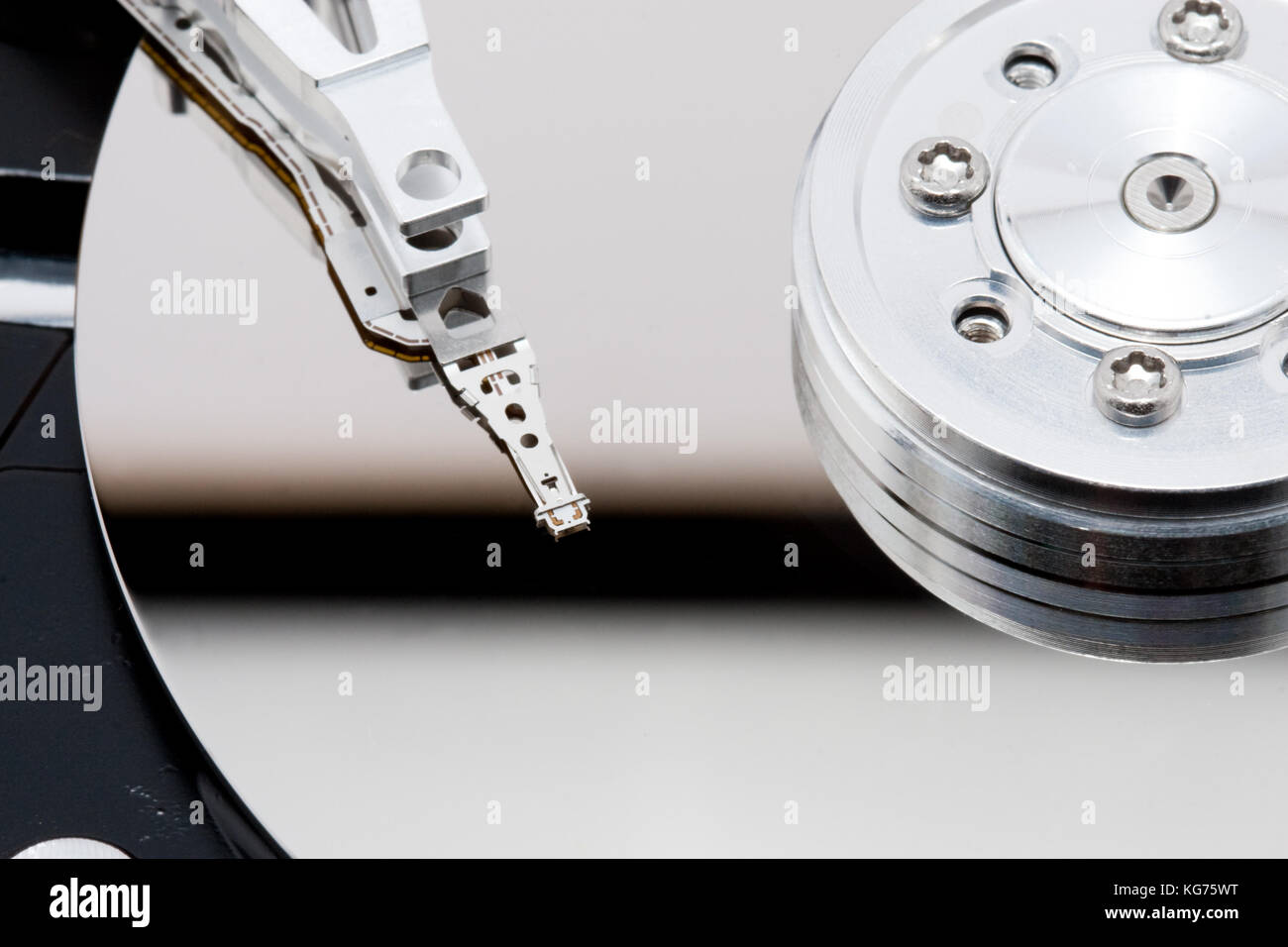 Close up inside of a computer harddrive with reflections of the read ...