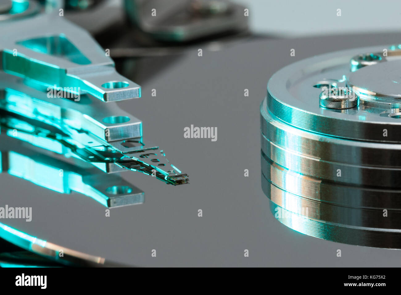 Close up inside of a computer harddrive with reflections of the read ...