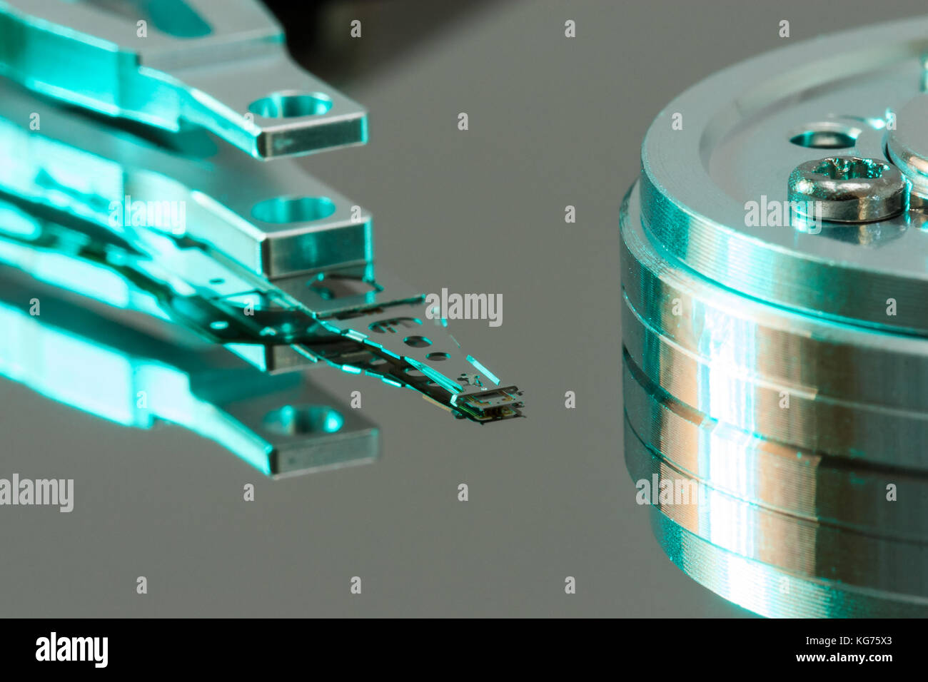 Close up inside of a computer harddrive with reflections of the read ...