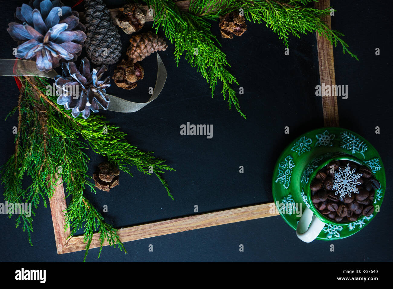Christmas concet with chalkboard, pine cones and coffee beans on dark ...