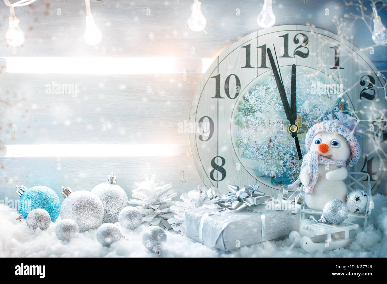 Christmas winter a background, the small snowman stands with a clock ...