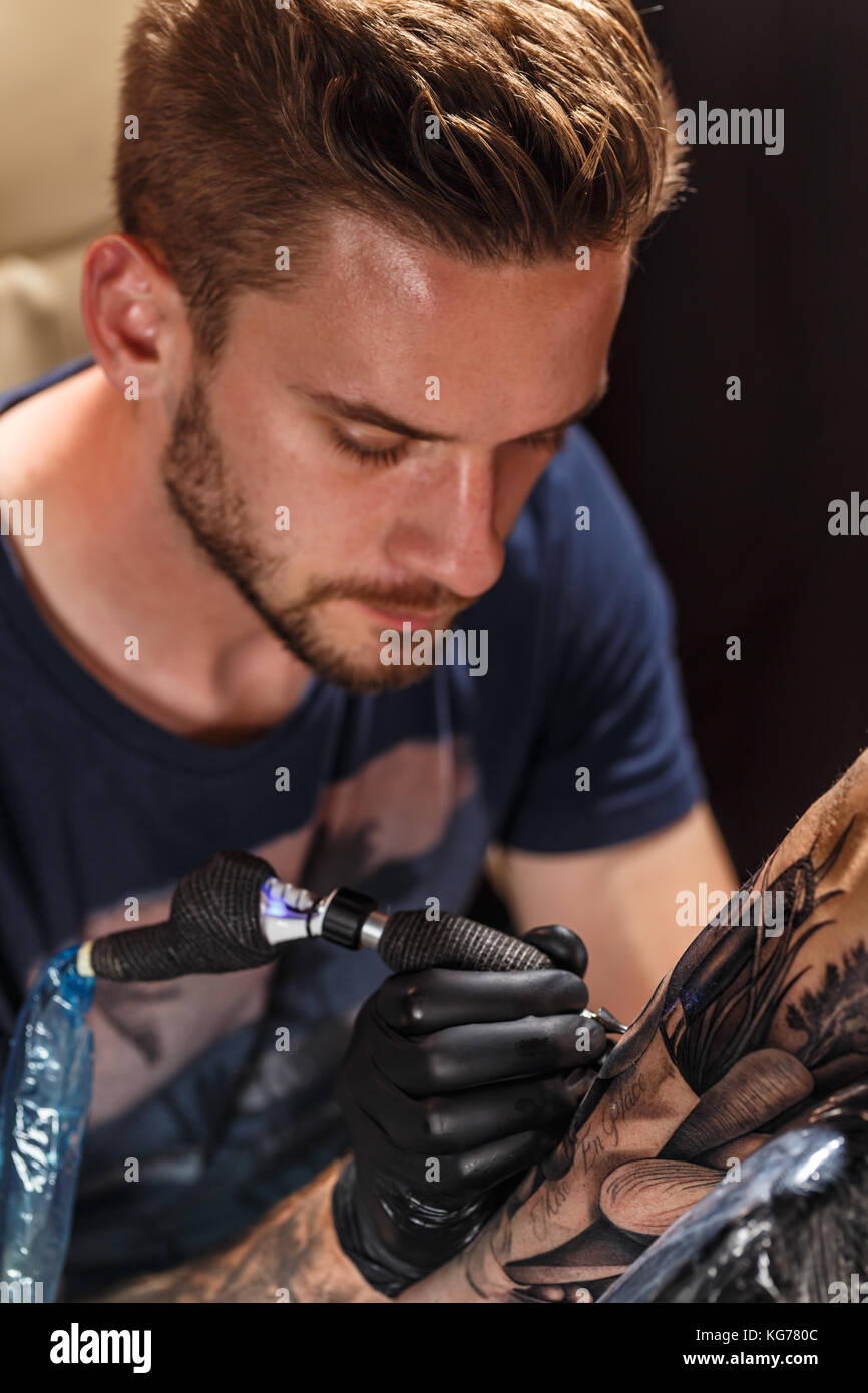 Tattoo artist demonstrates process hi-res stock photography and images ...