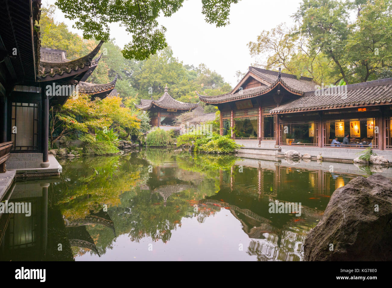 Chinese buildings surrounding a small lake in beautiful scenery ...