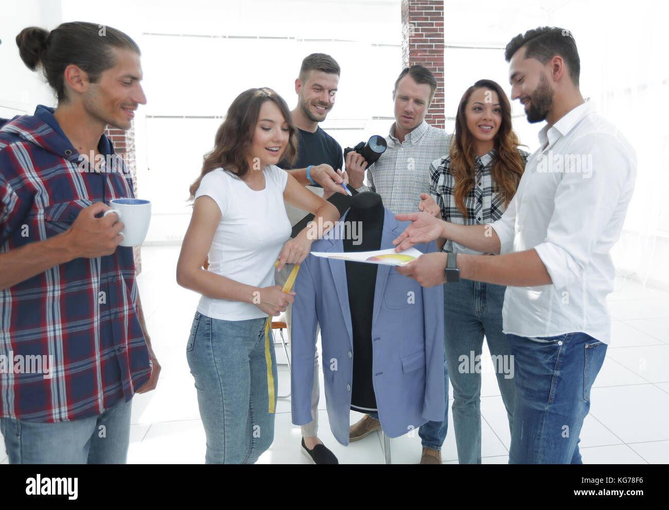 designers working with new models of men's clothing Stock Photo - Alamy