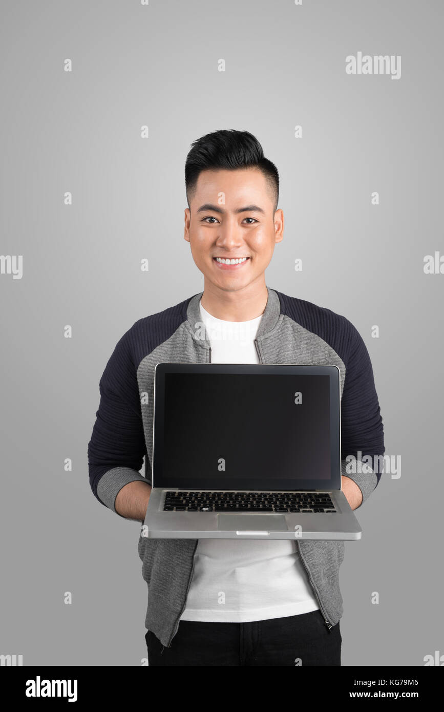 Asian man show with laptop computer screen Stock Photo - Alamy