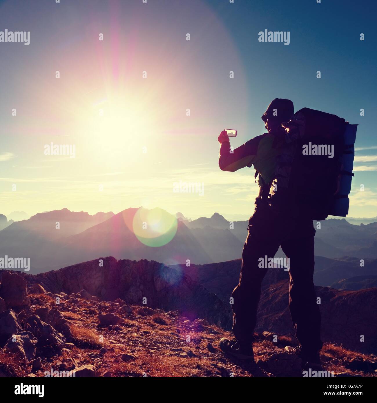 Lens flare light, strong defect. Hiker takes selfie photo. Man with big ...