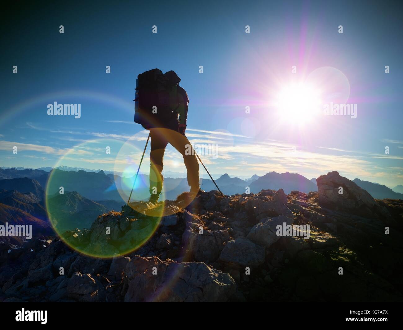 Lens flare light, strong defect. Tourist guide on trekking path with ...