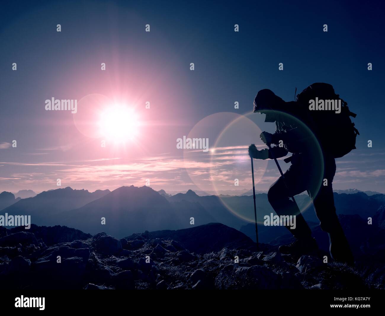 Lens flare light, strong defect. Tourist guide on trekking path with ...