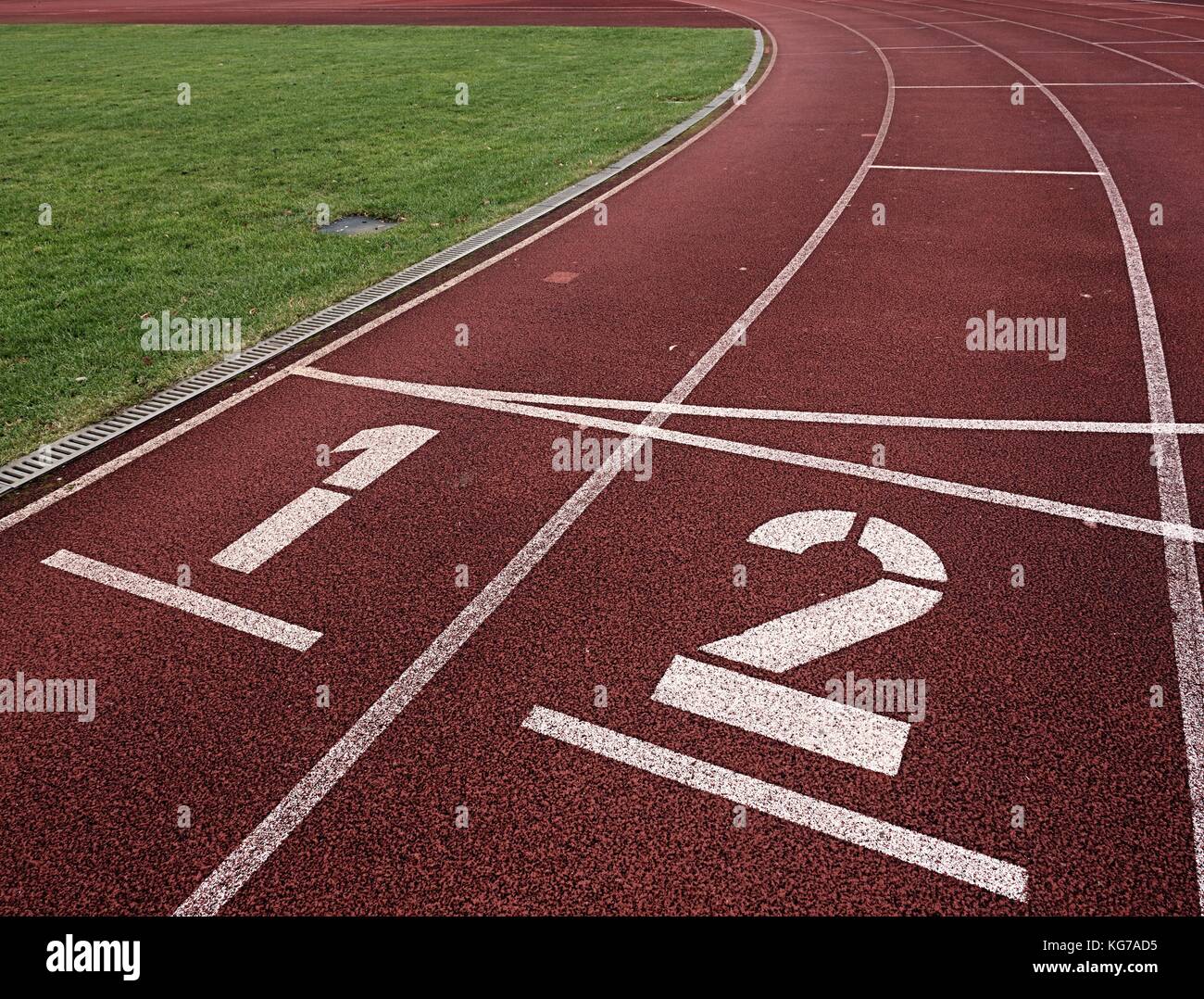 White track number on red rubber racetrack, texture of running ...