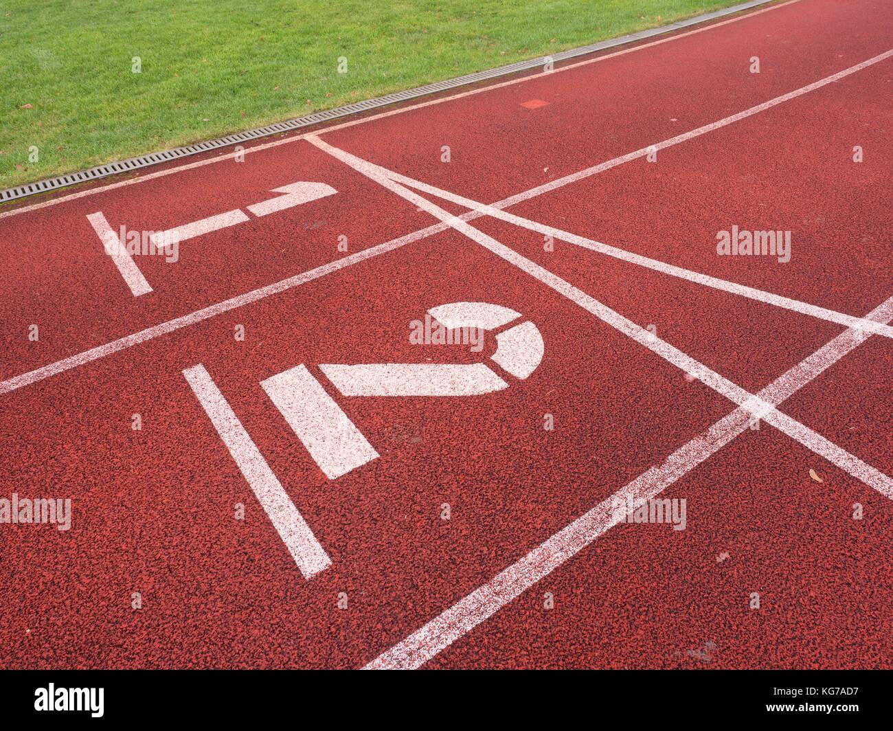 White track number on red rubber racetrack, texture of running ...