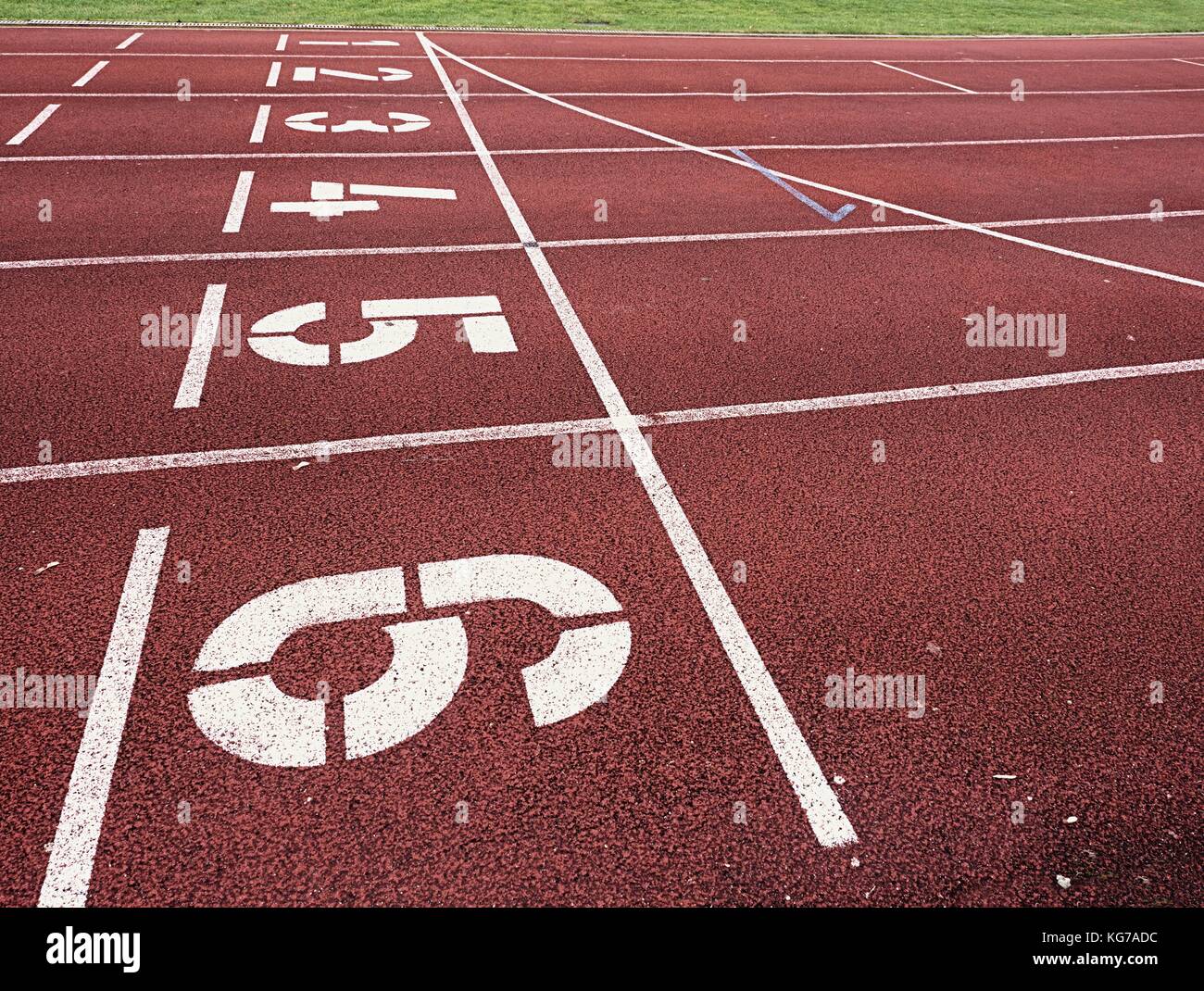 Start. Red running racetrack on the outdoor athletic stadium. Number ...
