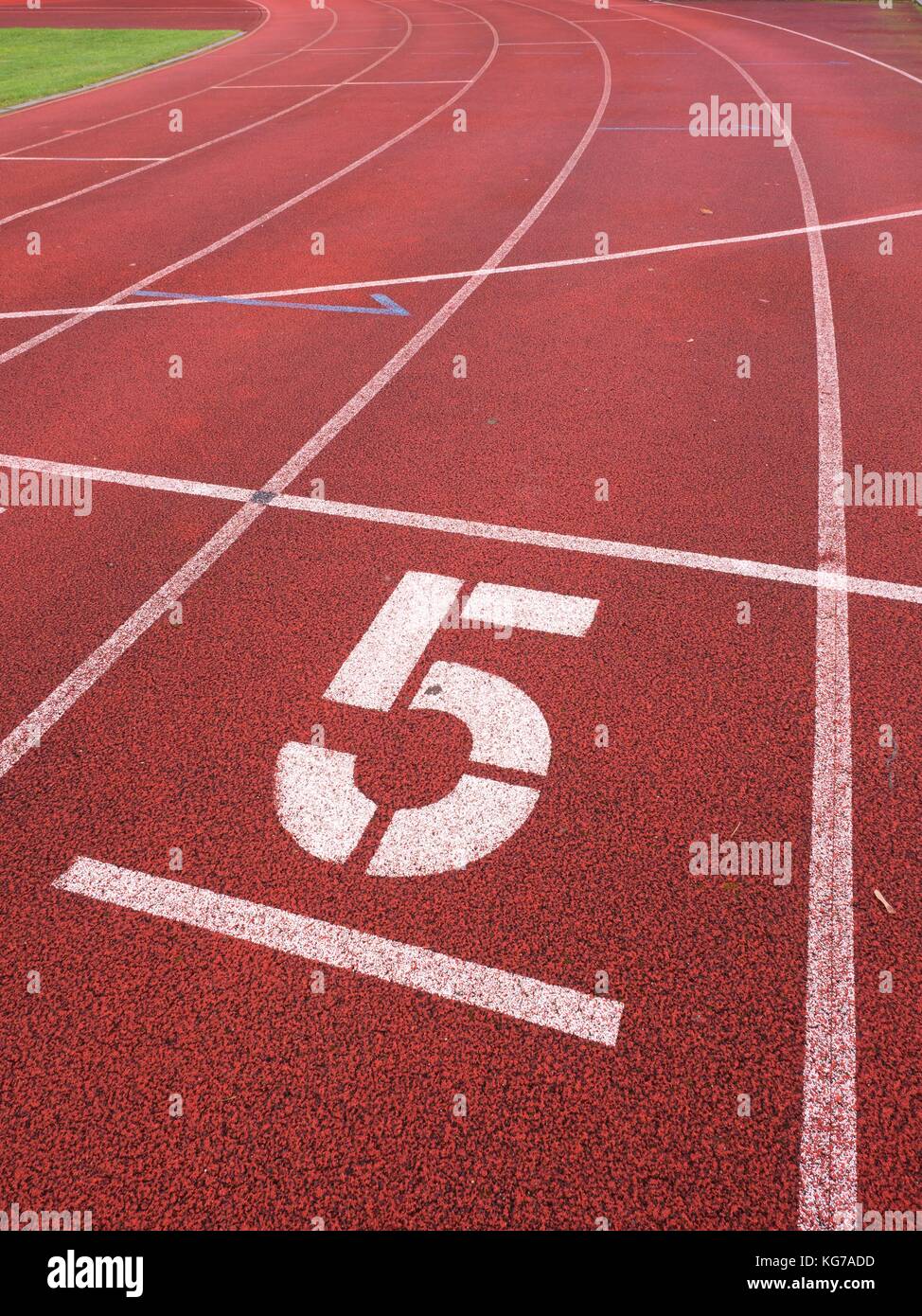Number five. Big white track number on red rubber racetrack. Gentle ...