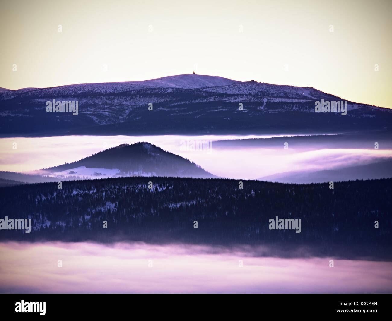Far mountain peak with observatory above creamy mist. Shinning lights ...