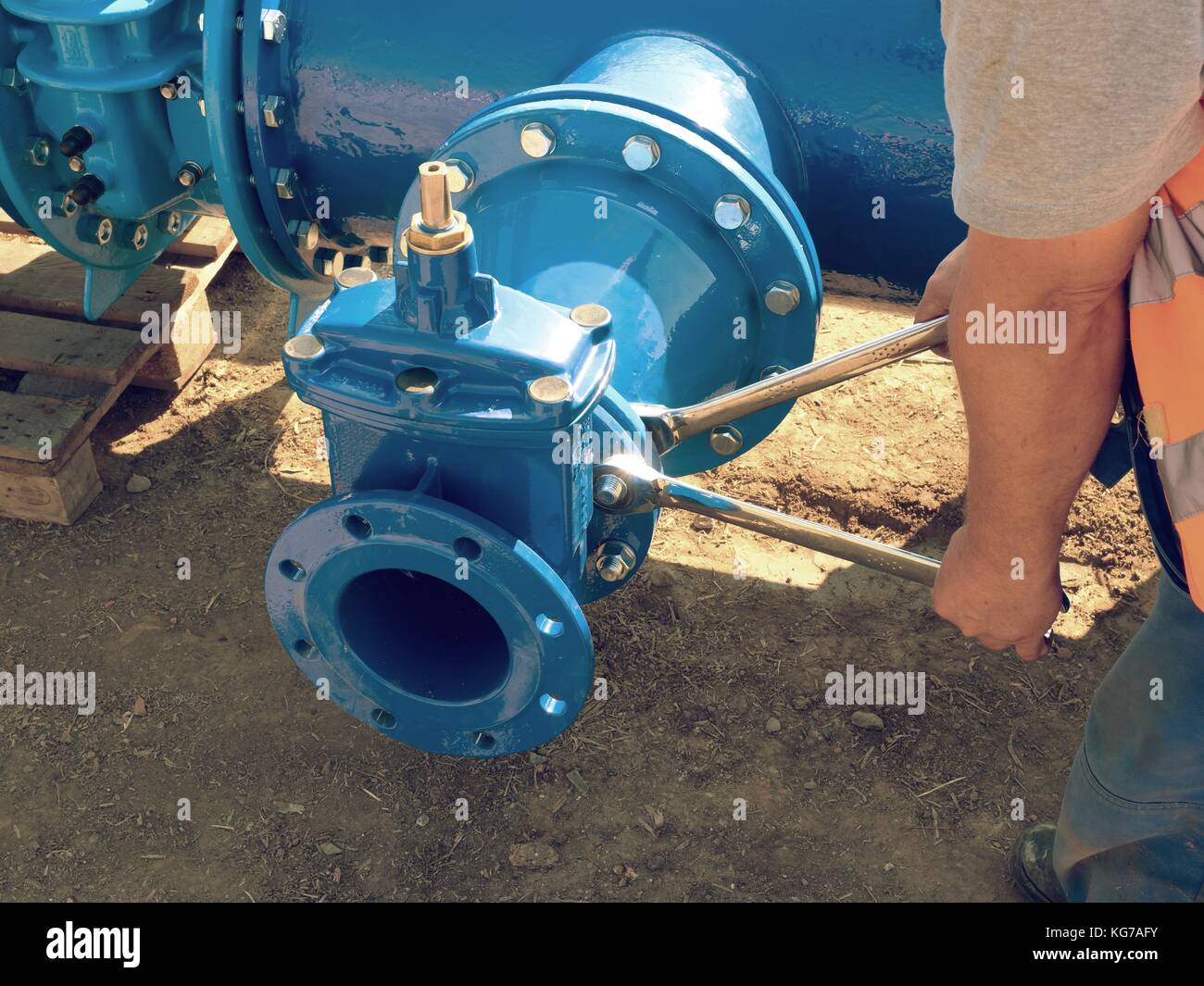 Worker hands screwing Gate valve with nuts on new dring water piping ...