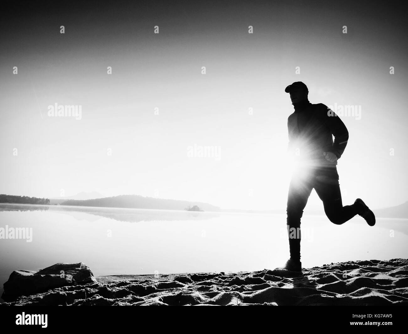 Slim young fitness man runner on beach, tropical trail runner. Cheerful ...