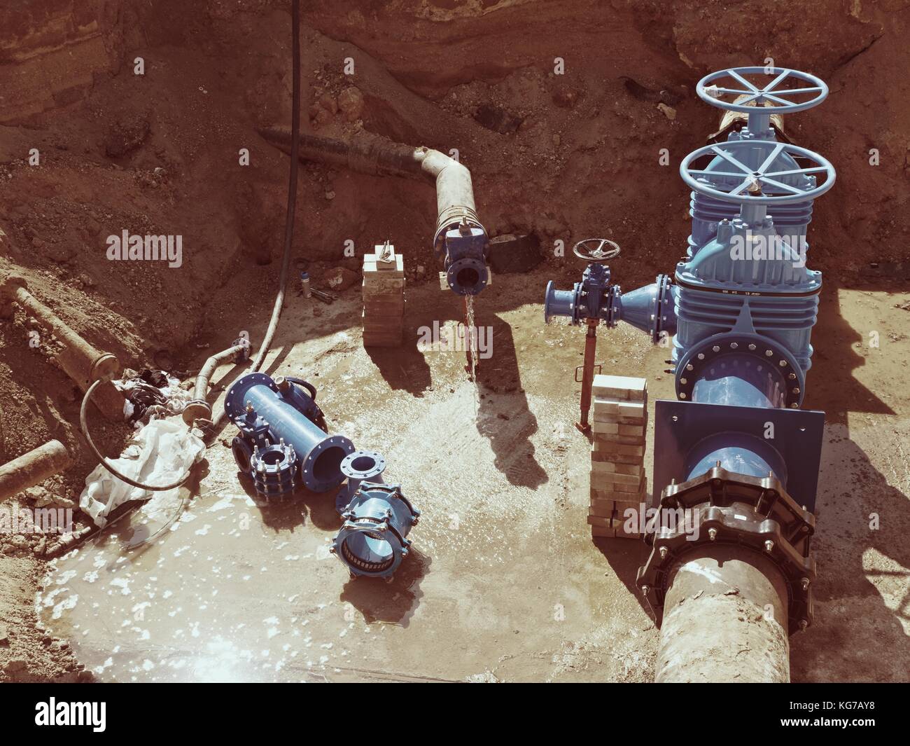 Oil, gas, water industry. Wellhead with valve armature underground. Dug ...