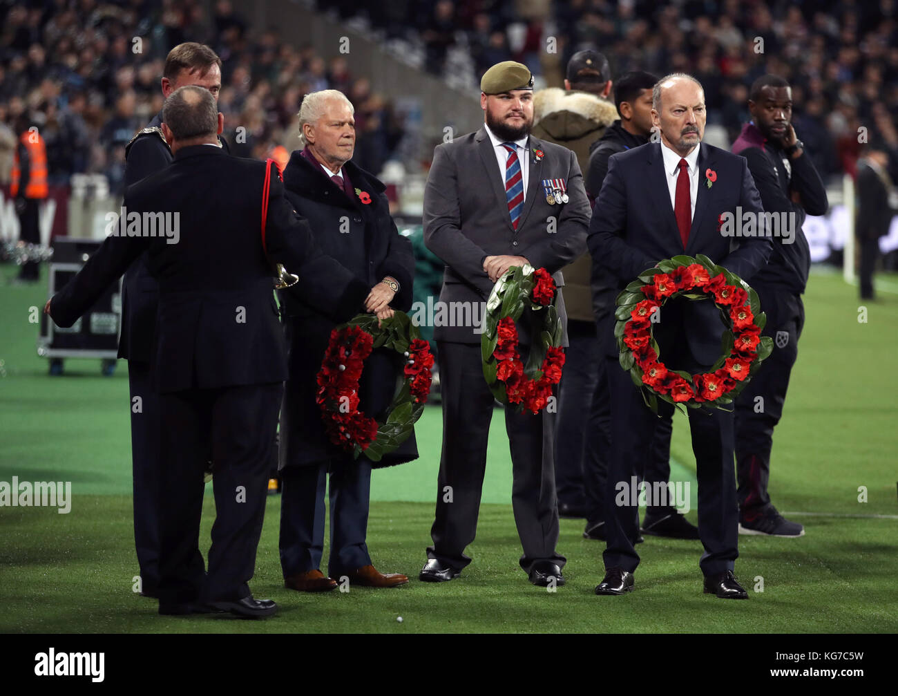 West Ham United Co Chairman David Gold (third left) with a poppy wreath ...