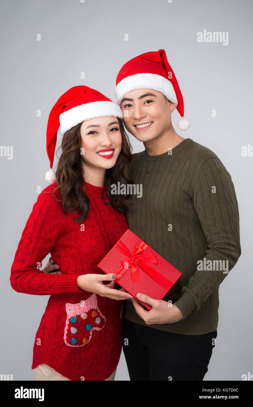 Romantic couple in a sweaters with gift box Stock Photo - Alamy