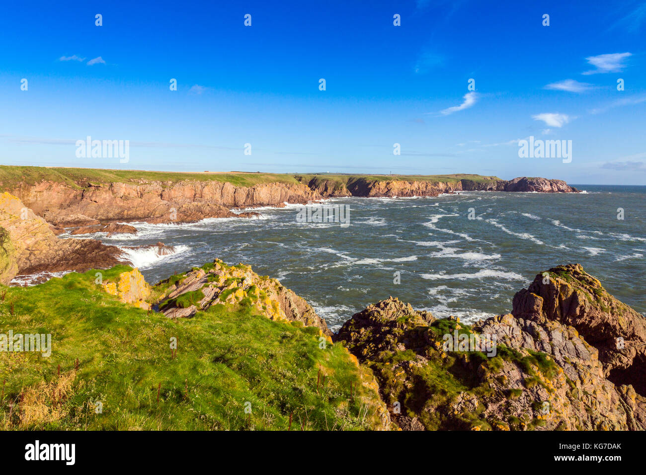 The dramatic sandstone cliff scenery north of the ruins of Slains ...